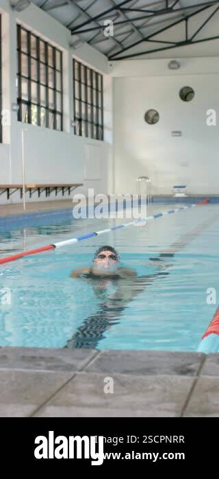 Vertical video: Swimming in indoor pool, woman celebrating victory with ...