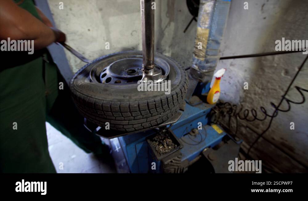 The process of removing a tire with the help of tire changer Stock ...