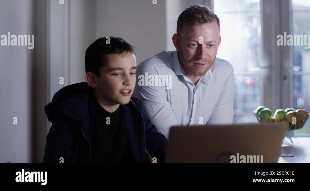 4K Dad & son spending time together at home & streaming a movie on ...