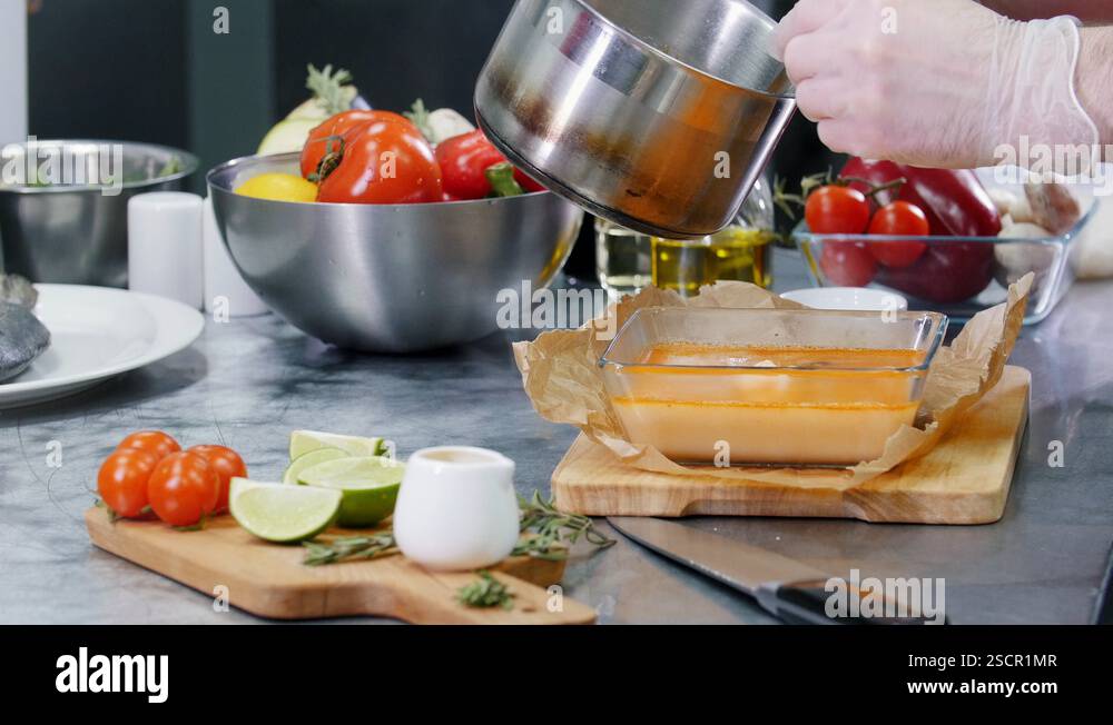 Restaurant kitchen. Chef adding seafood ingredients in the bowl with ...
