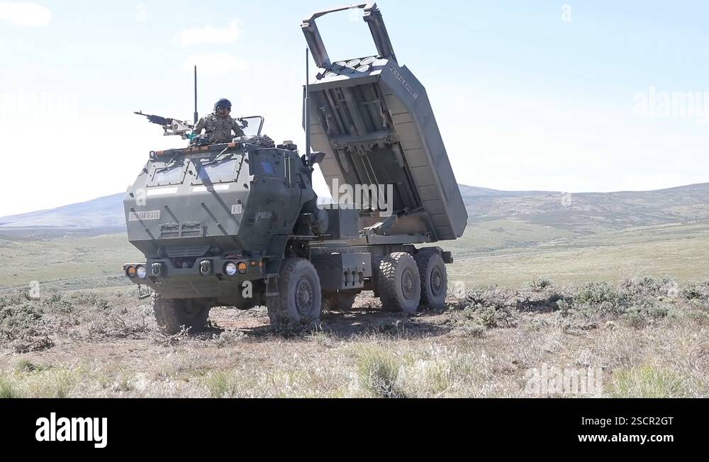 M142 High Mobility Artillery Rocket System launcher being lowered Stock ...