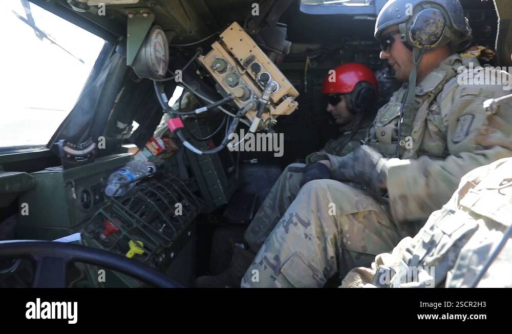 M142 High Mobility Artillery Rocket System crew sitting in armored cab ...