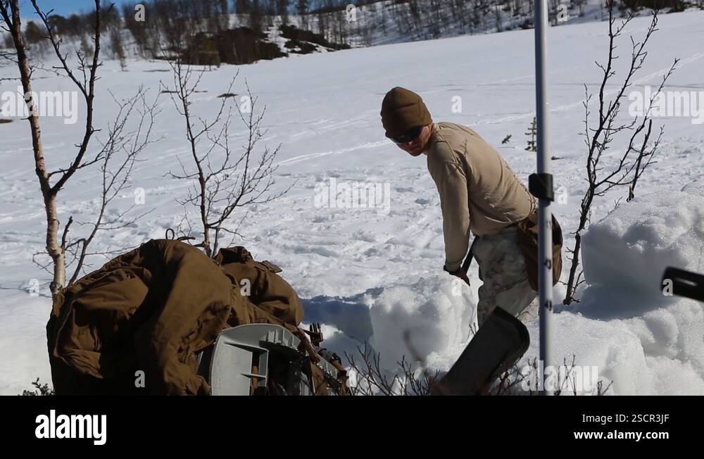 Marine constructing shelter with blocks of snow during cold weather ...