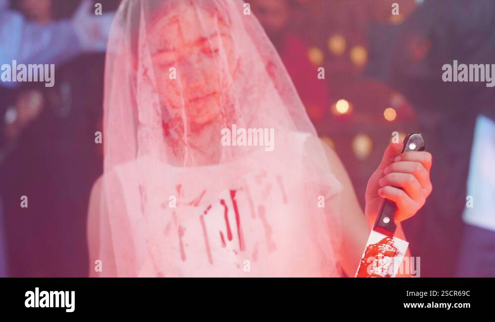 Teenage girl disguised as a dead bride covered in blood with a knife in ...