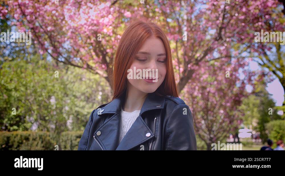 Gorgeous ginger model in leather jacket posing prettily into camera in ...