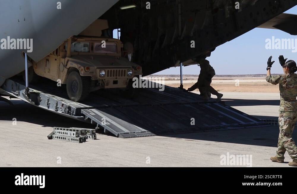 Humvee jeep being driven down ramp from C-17 Globemaster Stock Video ...