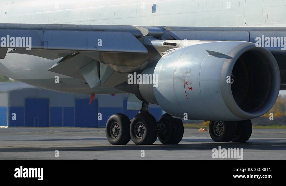 Jet turbine engine of aircraft on runway in airport. Working jet engine ...