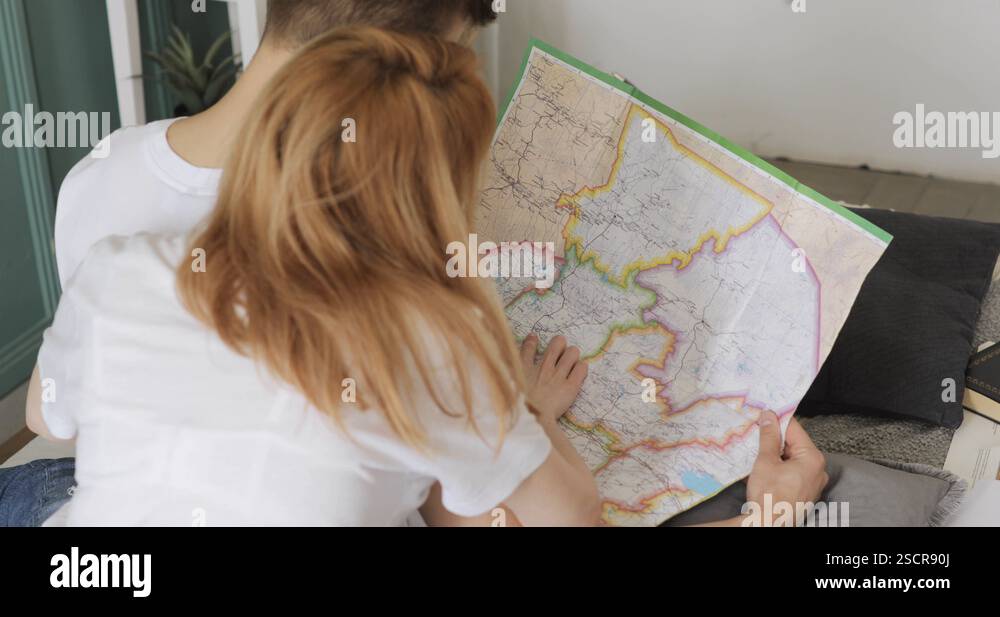 Man and woman are planning travel route by car trip using a map Stock ...