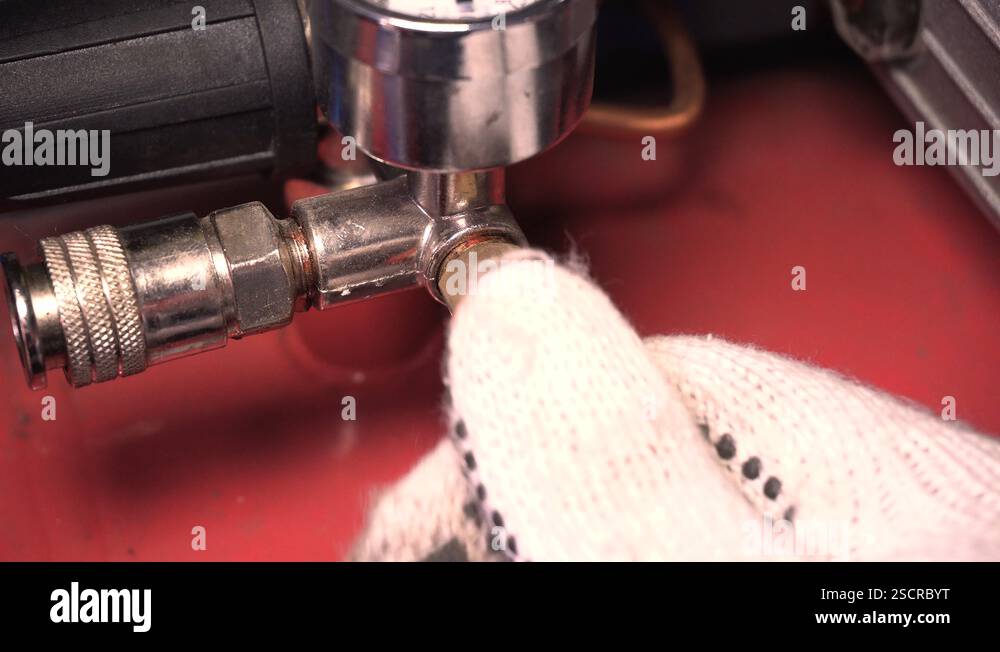 Bleeding compressed air from the receiver of the compressor, close up ...