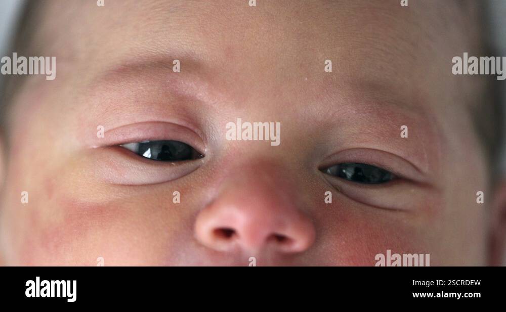 Infant newborn baby face and eyes in macro Stock Video Footage - Alamy