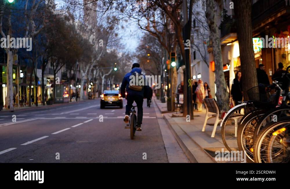 Sportive small guy bmx rider moves along road with cars in big busy ...