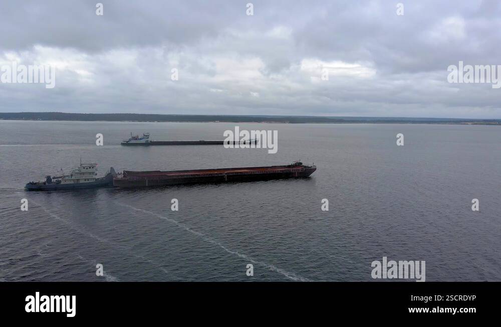 Aerial survey, top view. A barge with the ship sand is floating on the ...