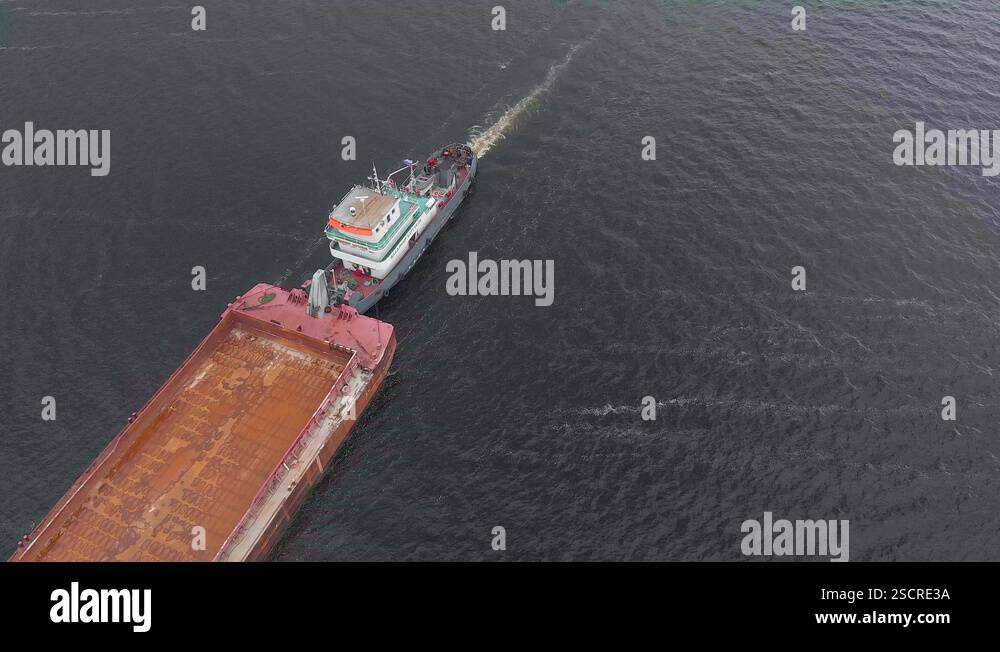 Aerial survey, top view. A barge with the ship sand is floating on the ...
