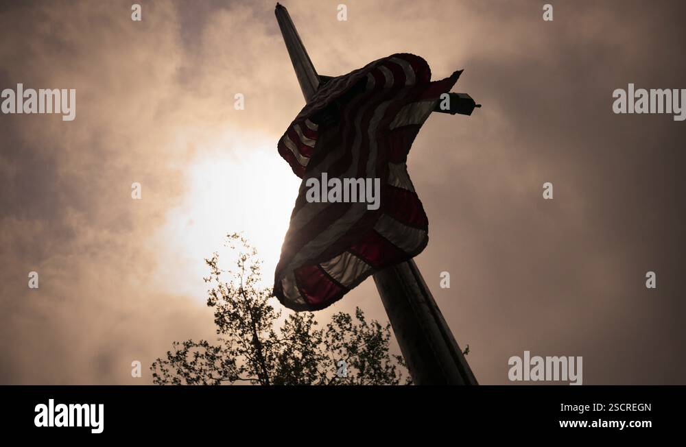Cinematic flag raised half way up with sun background - sepia cinematic ...