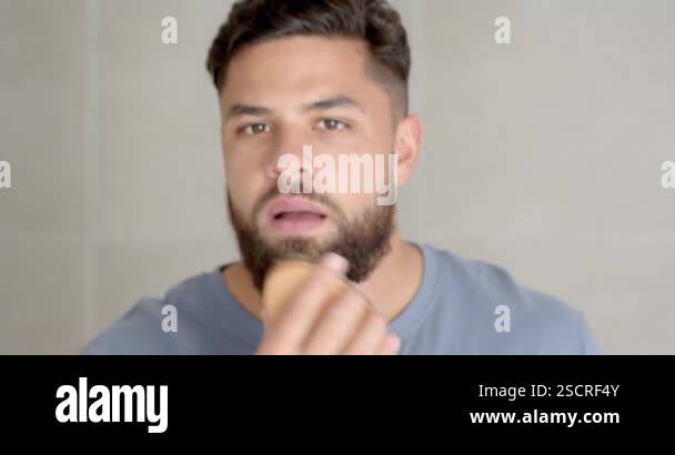 Man grooming beard with hands, focusing on personal care and hygiene ...