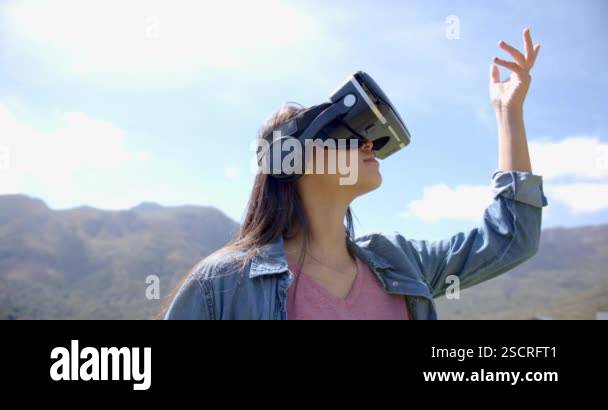 Using VR headset, asian woman exploring virtual reality outdoors in ...