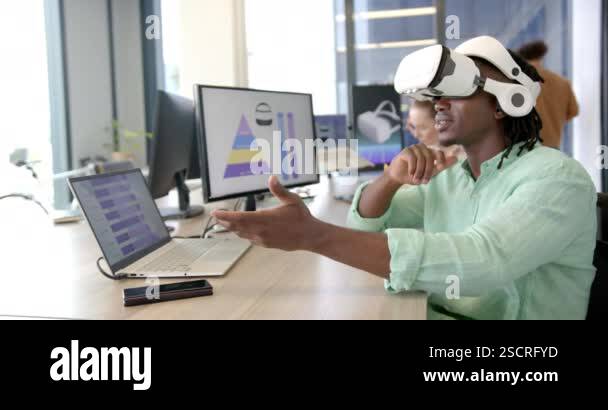 Using VR headset, man interacting with virtual interface in modern office. Technology, virtual ...
