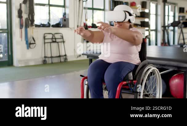 Using VR headset, woman with paraplegia in wheelchair participating in ...