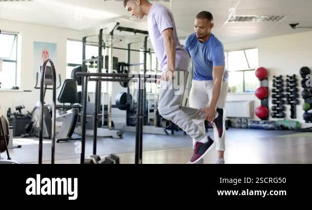 Using parallel bars for rehabilitation exercise, man with disability ...
