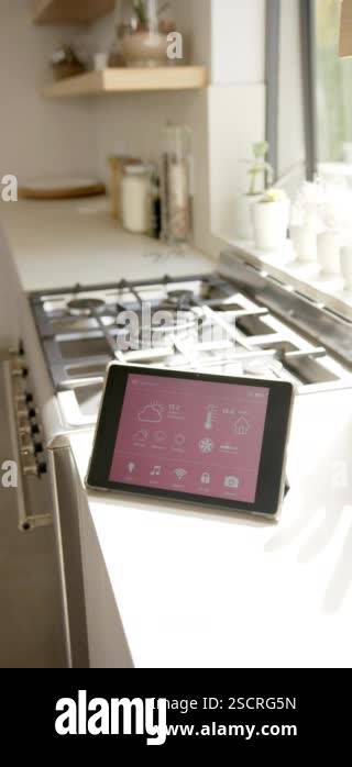 Vertical video: Tablet displaying smart home controls on kitchen ...