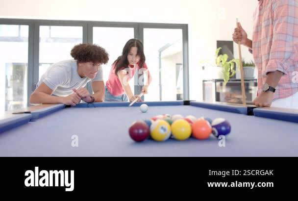 At home, Playing pool, diverse friends enjoying fun hangout, focusing ...