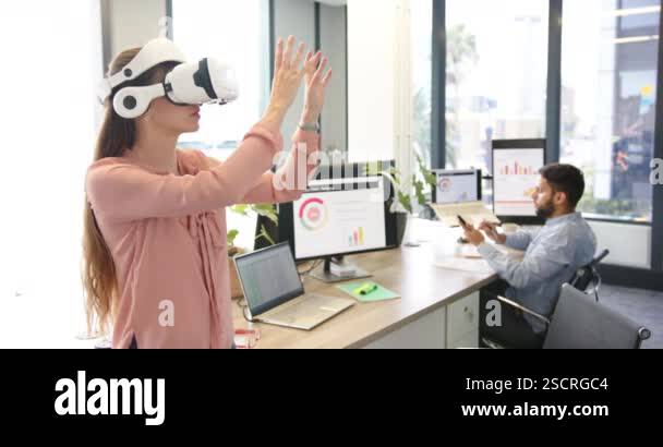 Using VR headset, woman exploring virtual environment in modern office ...