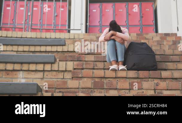 Sitting on school steps, student with backpack feeling sad and lonely ...