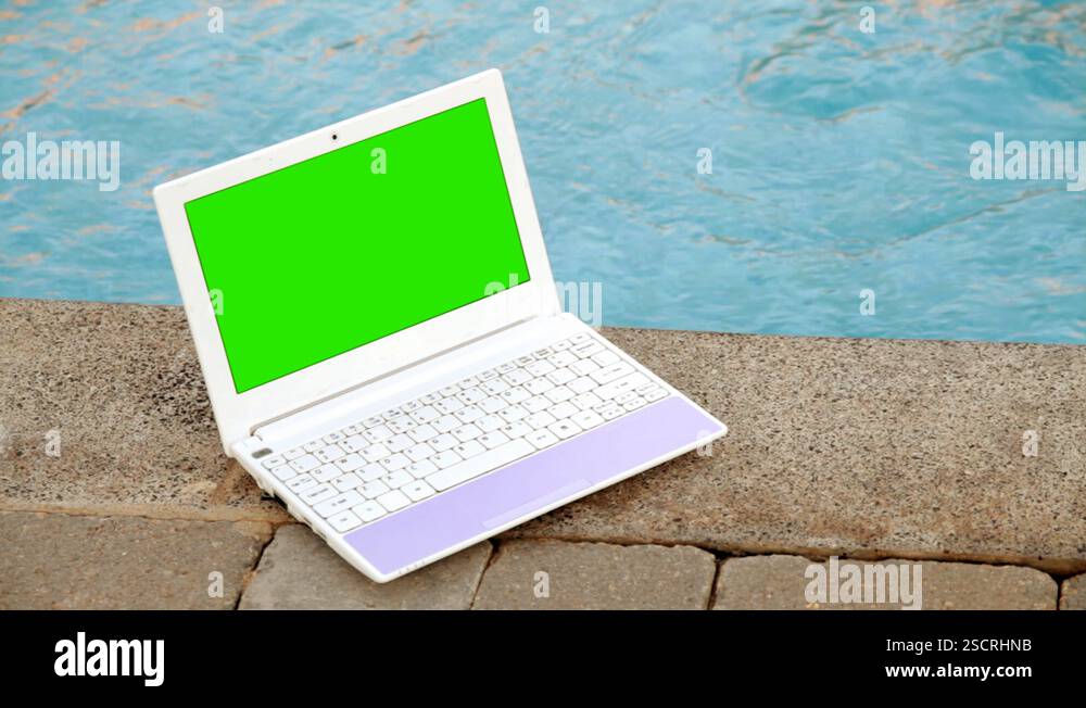 Laptop with green screen near to swimming pool Stock Video Footage - Alamy