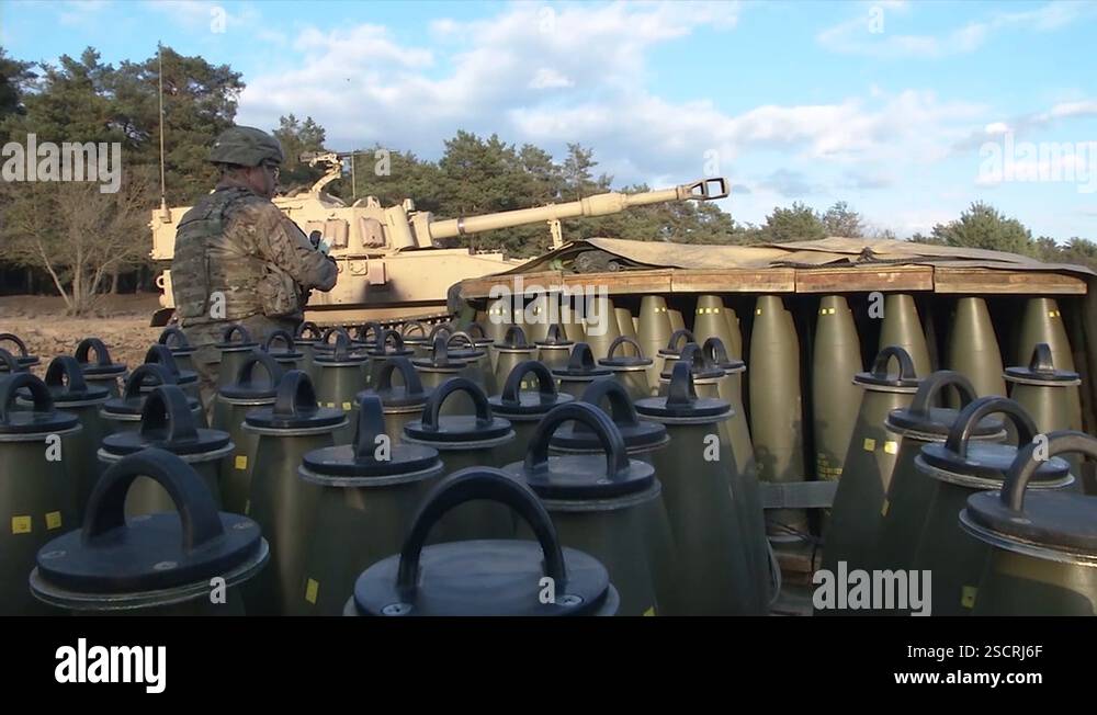 Self-propelled Howitzer tracking past artillery shells Stock Video ...