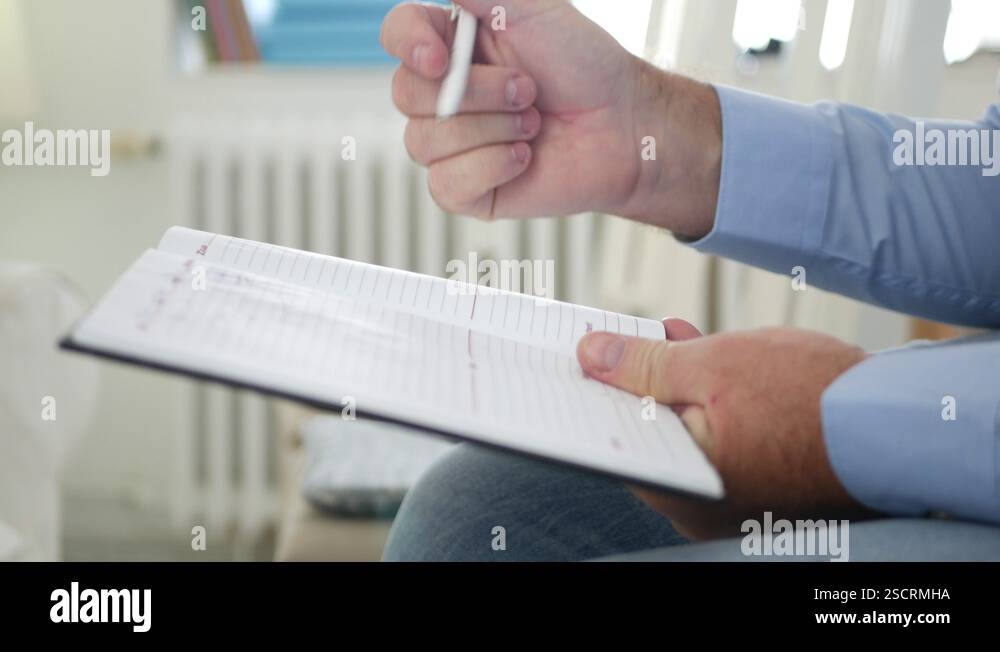 Man in Office Sit and Write in Agenda Pages Schedule for the Next ...