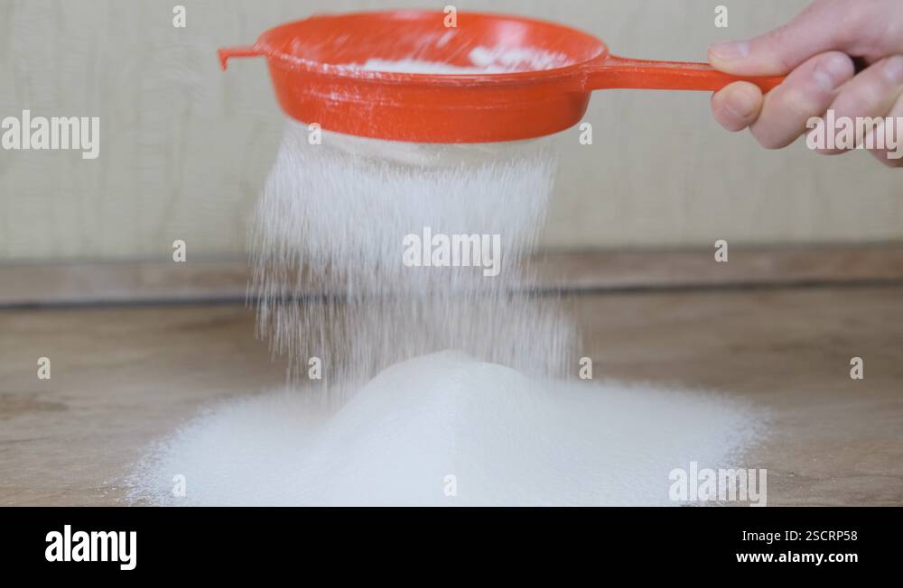 Sifting flour through a sieve Stock Video Footage - Alamy
