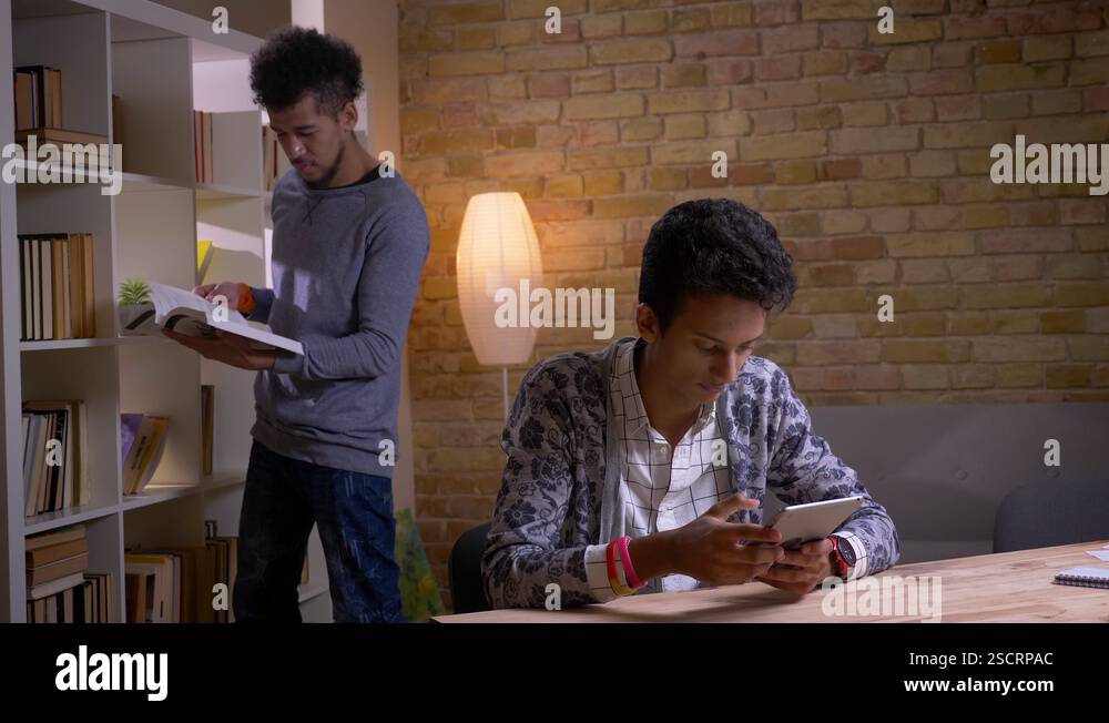 Closeup shoot of two culturally diverse students learning in the school ...