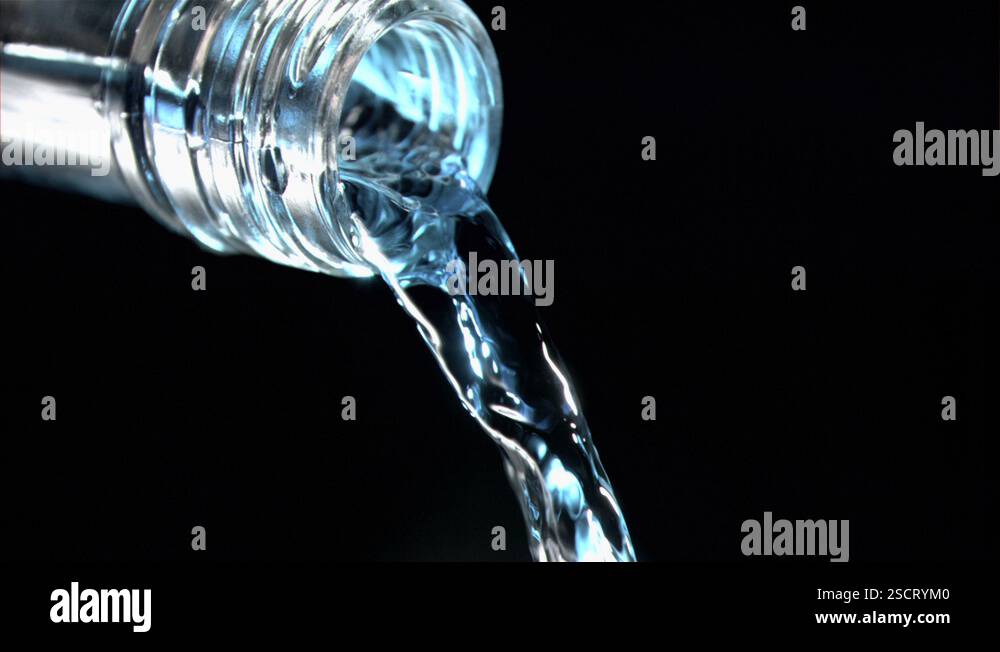 Close up, trickle of water in a super slow motion flowing of the glass ...