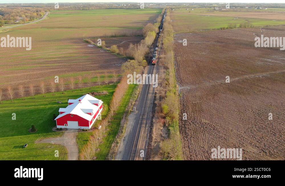 Freight train rolling across Springtime rural landscape at sunset Stock ...