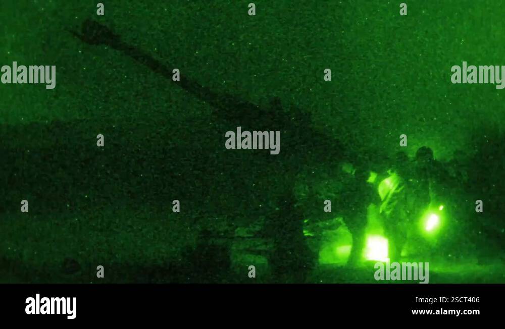Night vision imagery of soldiers firing M777 Howitzer at known enemy ...