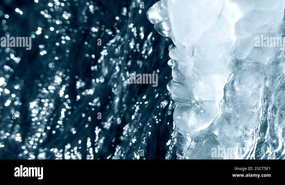 Thawing of ice on the edge of a waterfall brook close-up. With sound ...