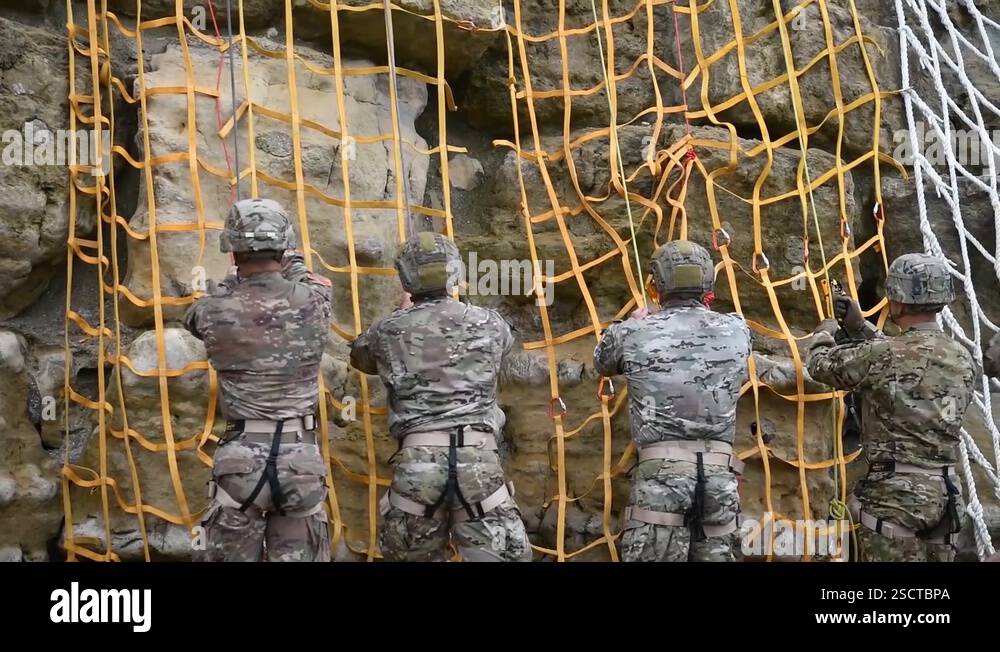 U.S. Army Rangers at base of cliff-face at Pointe Du Hoc, Normandy ...