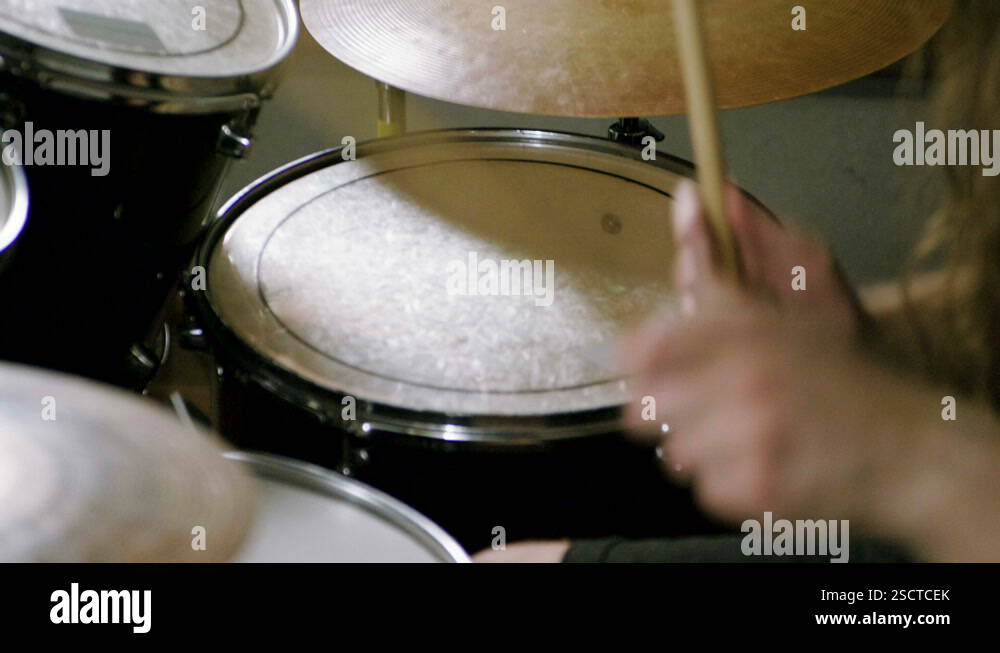 Close-up of drummer playing the drums by hitting it with sticks. Slow ...