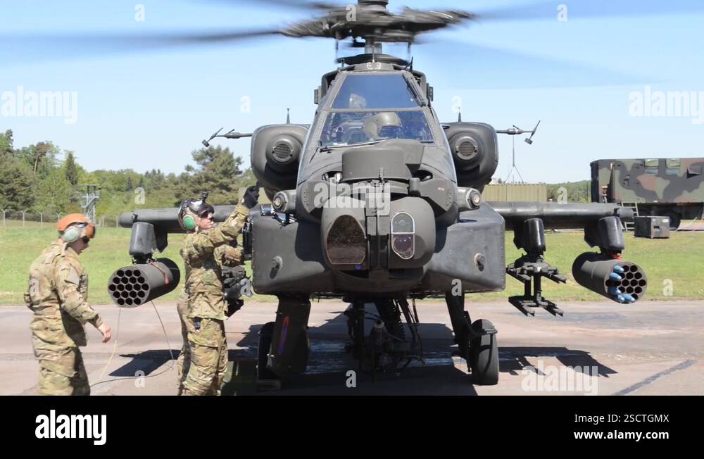 U.S. army aircraft armorers rearm AH-64 Apache helicopter Stock Video ...