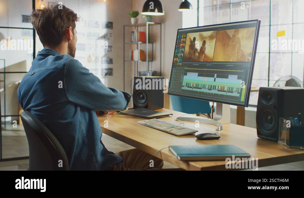 Male Video Editor Puts Headphones and Starts Working with Footage on ...