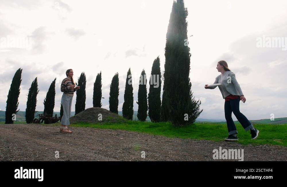 Two young women throw a plate at the green field Stock Video Footage ...