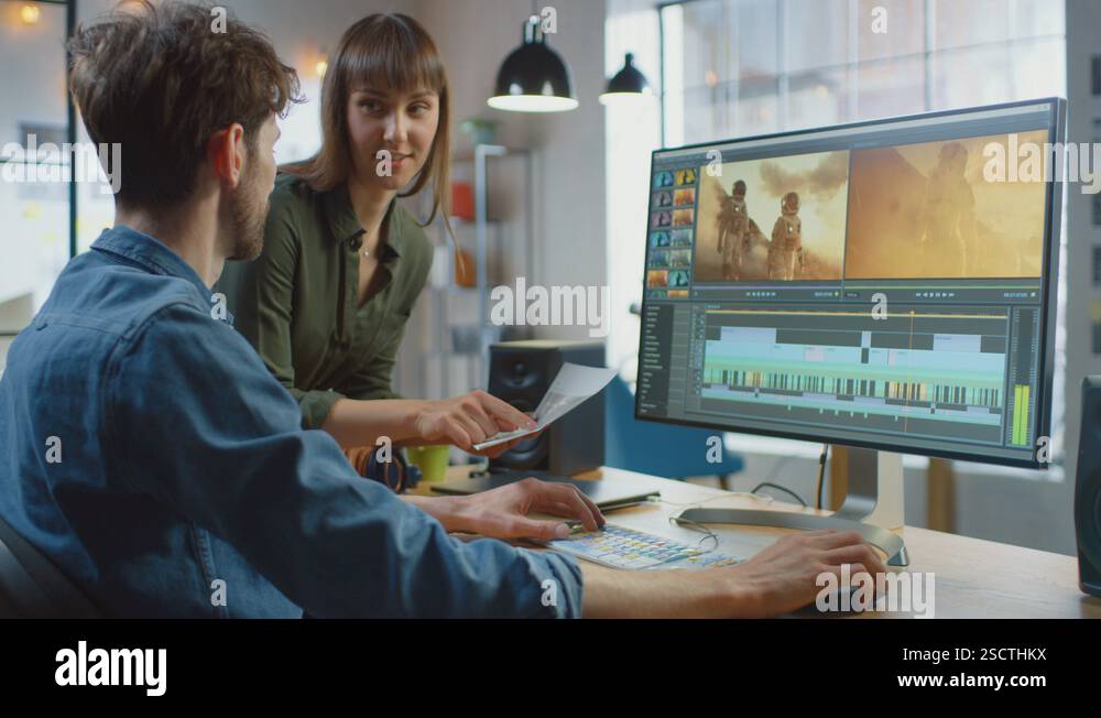 Beautiful Female Art Director Consults Handsome Video Editor Colleague ...