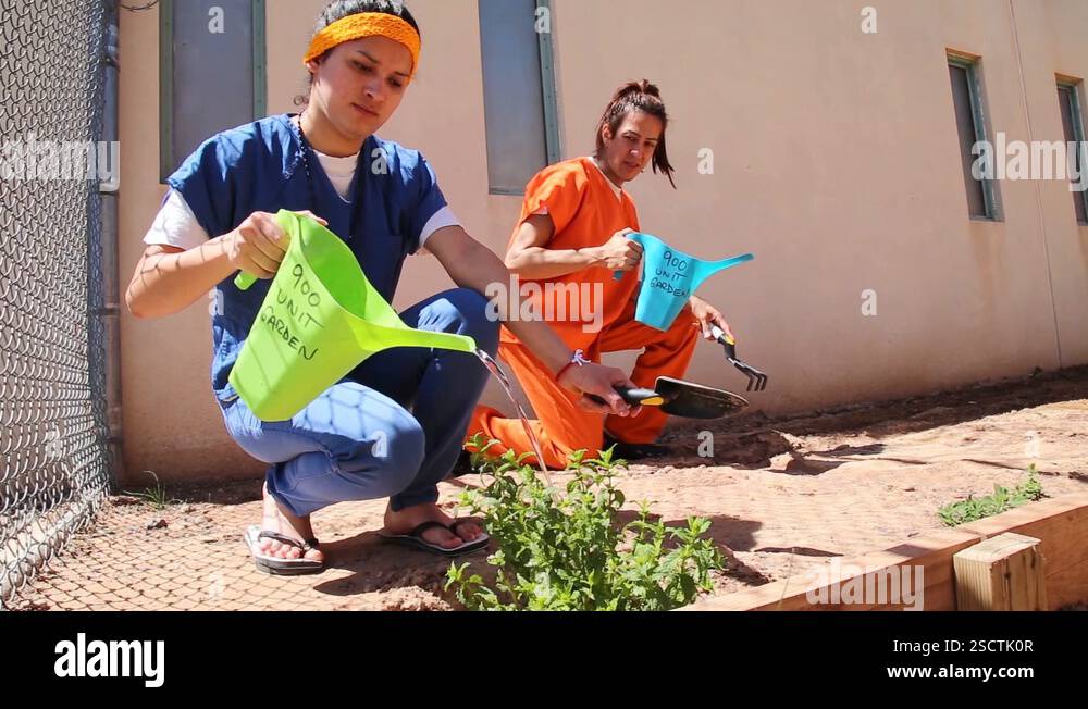 Transgender women watering plants in garden at Cibola County Detention ...