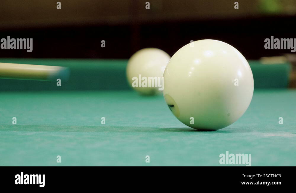 Game of billiards. Cue hitting ball with number 7 into pocket on ...
