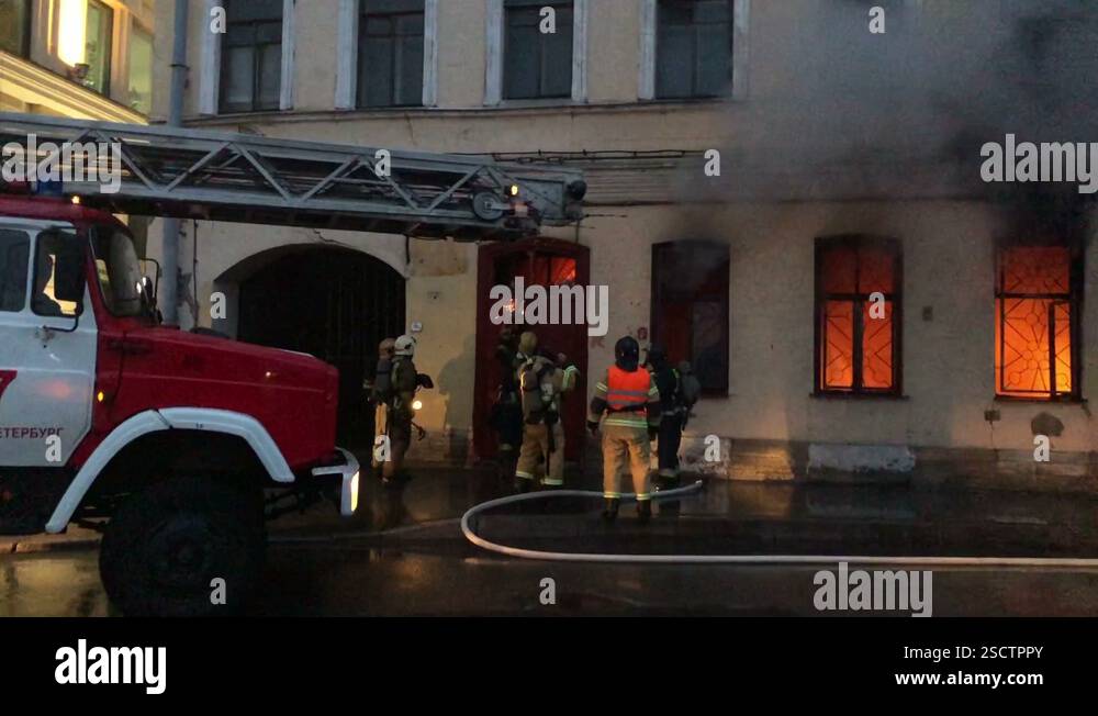 Fire in a residential building, firefighters are trying to saw the ...