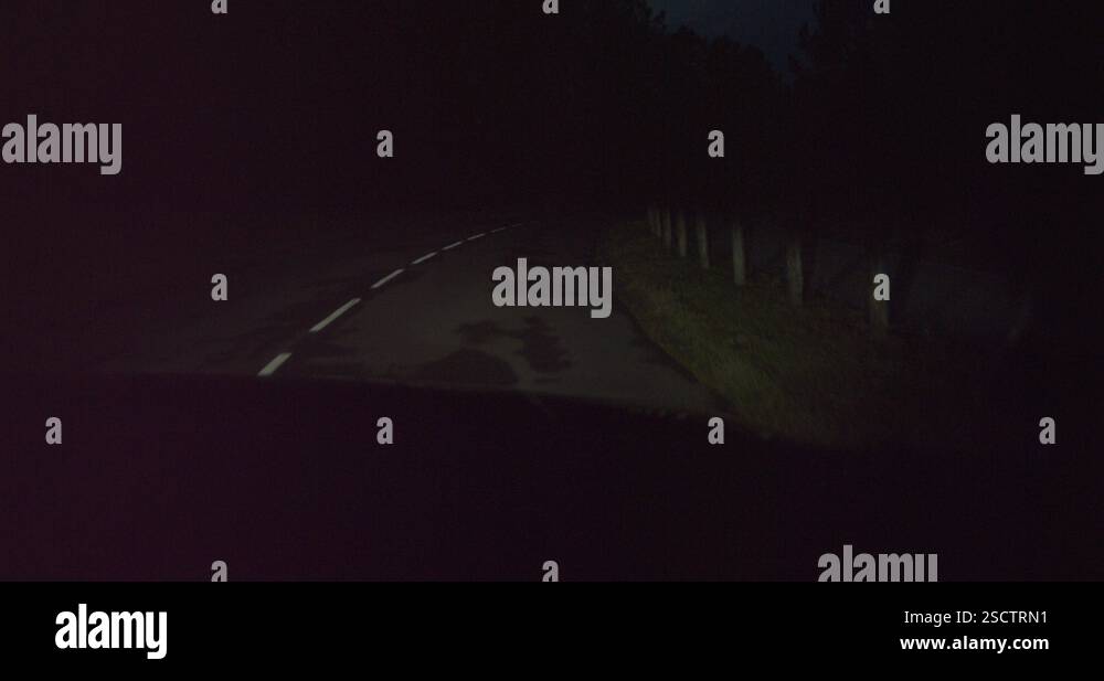 Scary isolated road during a winter night with white ground markings in ...