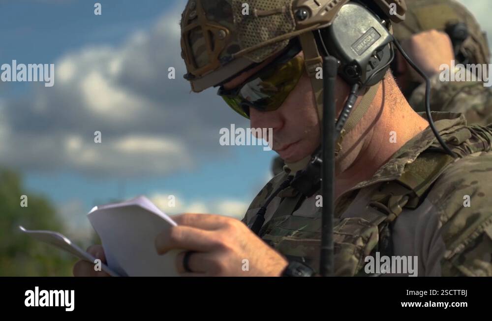 Airman reading from notebook during close air support exercise for Red ...