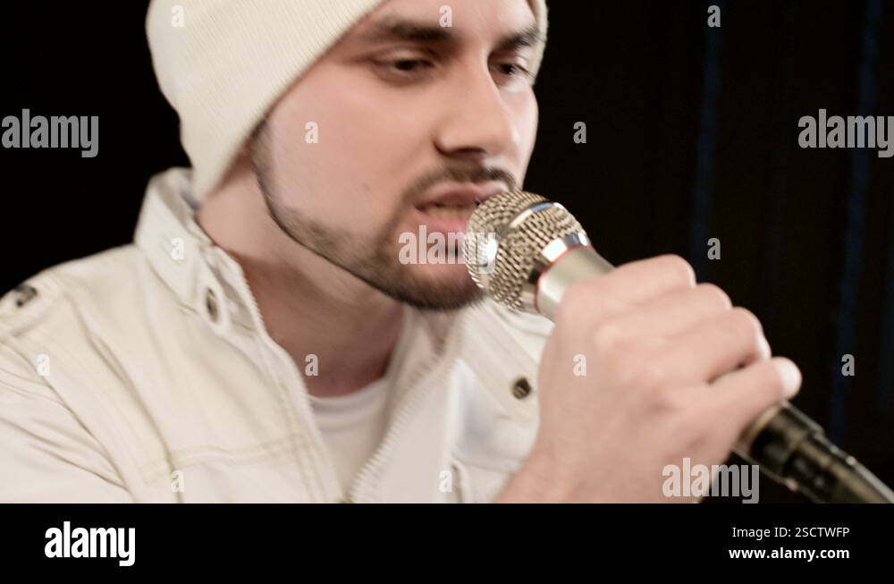 Close-up Frontman vocalist rock pop with a stylish beard in white ...