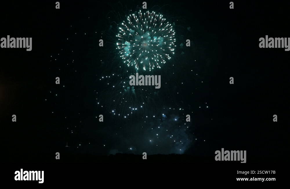 Dazzling large-scale fireworks with bright lights above the horizon. Live camera Stock Video ...