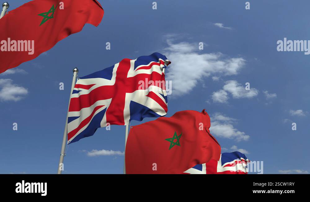 Waving flags of Morocco and the United Kingdom on sky background ...